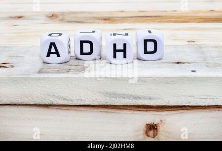 ADHD in letter dice on a rustic and natural wood with copy space ADHD ...