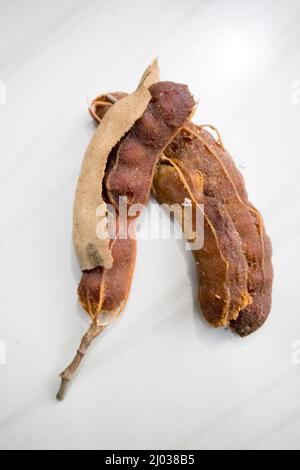 Some peeled tamarind with the shell in a white background Stock Photo ...