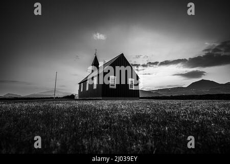 A black church known as Buoakirkja, in the Snaefellsnes peninsula at ...