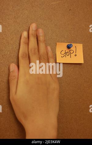 Stop text written on sticky note designed with woman hand Stock Photo ...