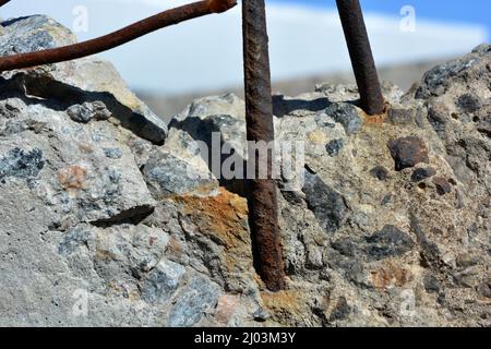 Building materials, a broken piece of gray reinforced concrete wall ...