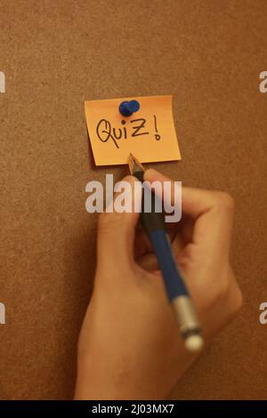 Quiz written on sticky note concept designed with woman hand Stock ...