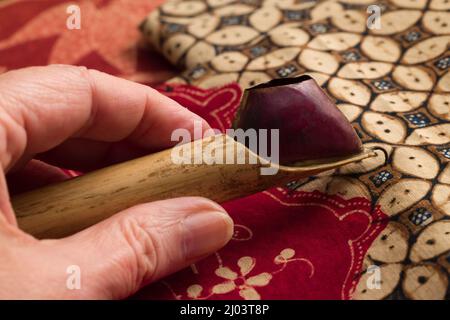 Batik fabrics are made with the use of a canting and hot wax, which is ...