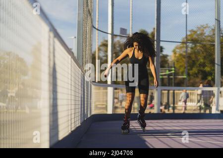 Closeup shot of a beautiful girl rolling in the park on a sunny day ...