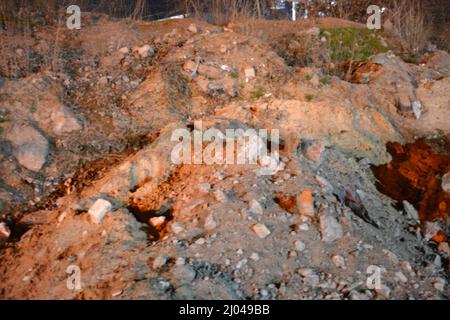 An industrial area, hills and mountains of gray slag, sand, building ...
