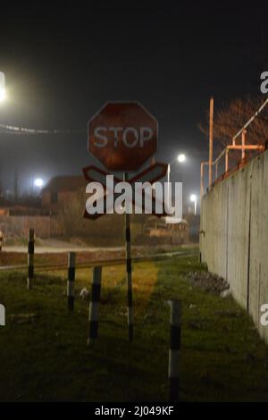 Road signs, a large metal, round stop sign at the junction of roads in ...