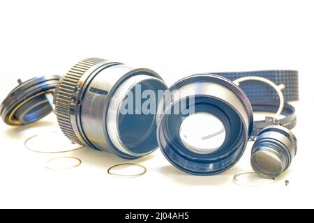 Clean and disassemble the lens for photography into its component parts ...