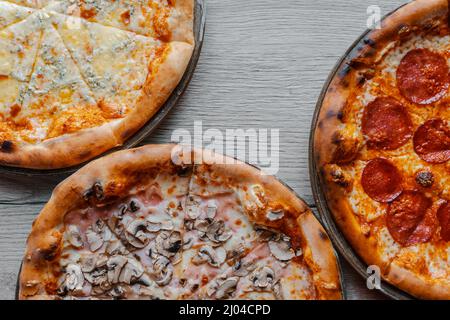 Photo of multiple pizzas on table Stock Photo - Alamy