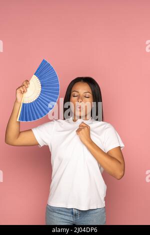Exhausted african woman using paper fan suffer from heat sweating ...