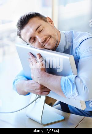 Office worker hugging her computer Stock Photo - Alamy