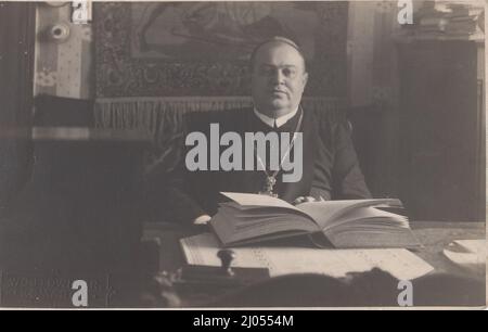A proud high ranking roman catholic priest is posing for the camera at ...