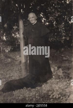 A proud high ranking roman catholic priest is posing for the camera in ...