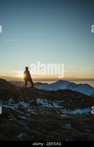 Male on a snowy mountain on a sunny morning Stock Photo - Alamy