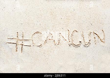Handwriting words "Cancun" on sand of beach Stock Photo - Alamy
