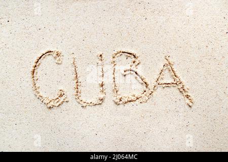 Handwriting words "Cuba" on sand of beach Stock Photo - Alamy