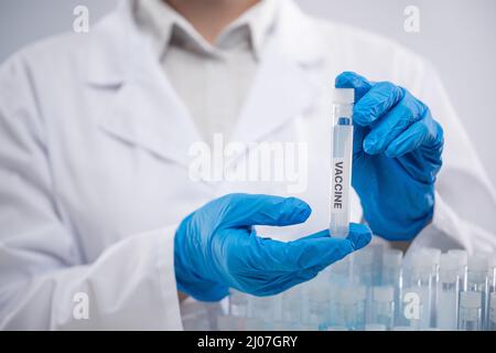 Macro shot of female microbiologist in blue protective gloves holds ...