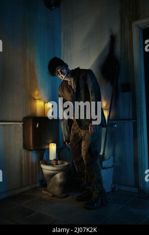 Full-length portrait zombie killer standing by lavatory Stock Photo - Alamy