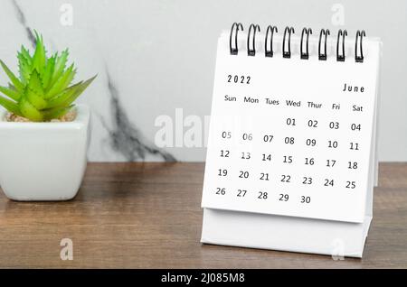The June 2022 desk calendar with plant pot on wooden table Stock Photo ...
