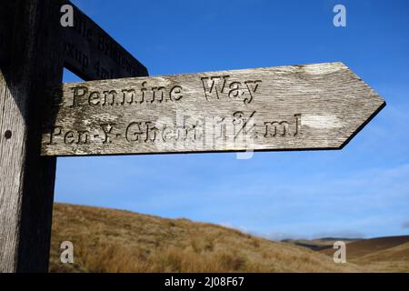 Wooden Pennine Way and Yorkshire Three Peaks signpost covered in frost ...