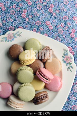 French meringue cookies and flowers on white background Stock Photo - Alamy