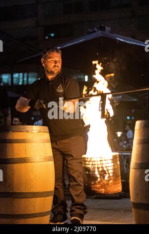 Man burning the inside of a wooden barrel Stock Photo - Alamy