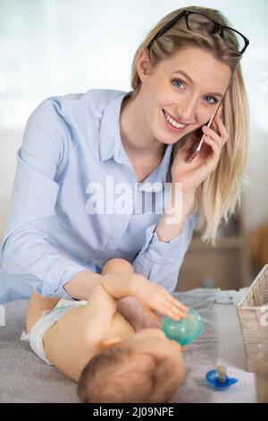 Mother changing a baby's nappy Stock Photo - Alamy