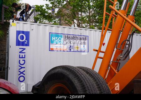 Indian Workers installing the oxygen generation plant on platform in a ...
