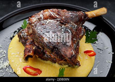 Fried leg of lamb with garnish and pepper Stock Photo - Alamy
