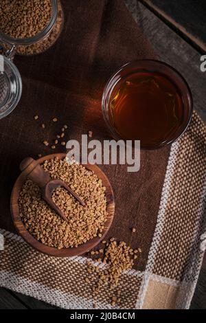 Glass of Egyptian fenugreek yellow tea, Helba or Methi Dana drink and ...
