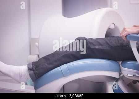 Patient in fully open MRI CAT Scan scanning arm, elbow, forearm, hand ...