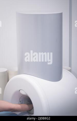 Patient in fully open MRI CAT Scan scanning arm, elbow, forearm, hand ...