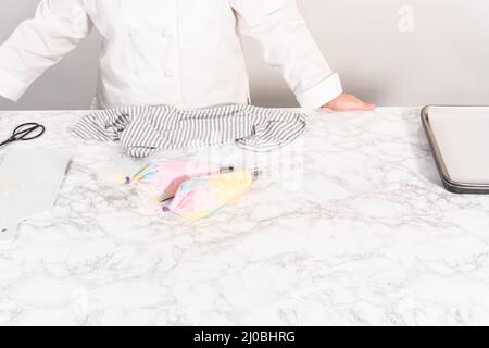 Colorful meringue in piping bags with metal piping tips Stock Photo - Alamy