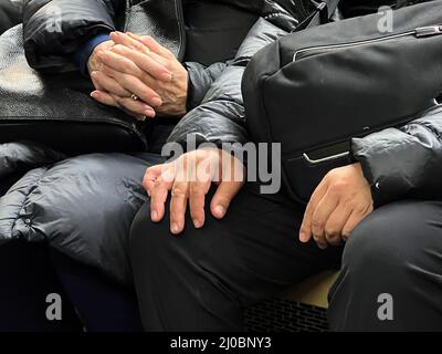 Hands at rest riding nthe F Train in New York City Stock Photo - Alamy