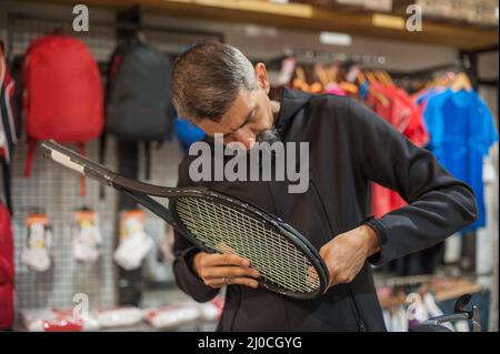 Stringing Machine. Tennis stringer doing racket stringing in his ...