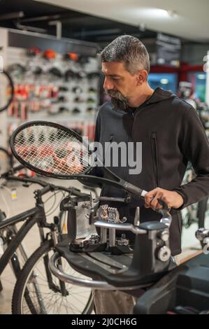 Stringing Machine. Tennis stringer doing racket stringing in his ...