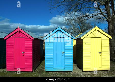 Iconic, old fashioned beach huts. Typical British seaside scene at ...