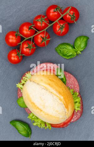 Sub sandwich baguette with salami portrait format from above on wooden ...