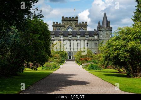 Beautiful way to Inveraray castle surrounded by green trees and bushes ...
