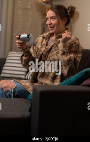 Woman with gamepad in hands playing games emotions lifestyle leisure ...