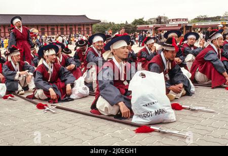 Actors dressed as guards and court officials prepare for their ...