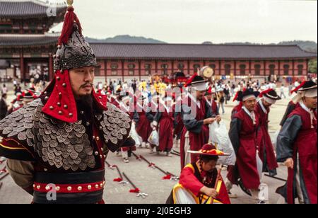 Actors dressed as guards and court officials prepare for their ...