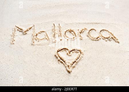 Handwriting words "Mallorca" on sand of beach Stock Photo - Alamy