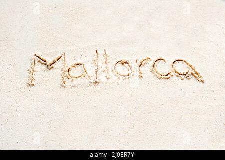 Handwriting words "Mallorca" on sand of beach Stock Photo - Alamy