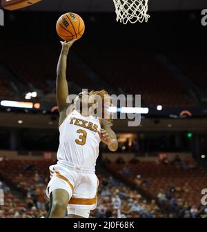 Texas guard Rori Harmon (3) goes to the basket between Arkansas guard ...