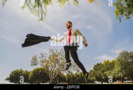 Excited businessman running fast, racing and jumping Stock Photo - Alamy