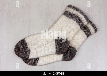 male white knitted socks of dog fur on white background close-up, top ...