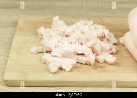 Fresh and raw lard finely chopped, meat on a cutting board. Salo ready ...