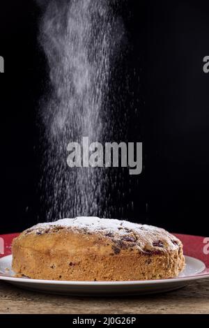 Falling icing sugar on fresh donuts on old wooden table Stock Photo - Alamy