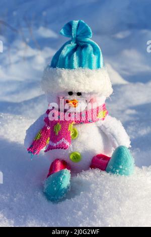 snowman sitting on the snow with christmas tree decoration with red ...