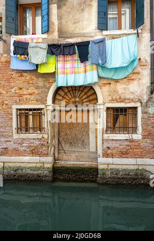 Small canal in Venice with clothesline and laundry Stock Photo - Alamy